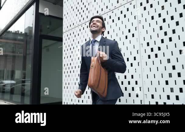 Happy skilled business man walking and dancing to celebrate for getting ...