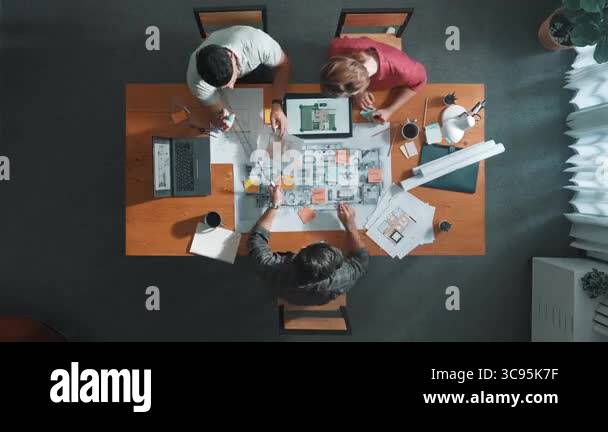 Time lapse of civil engineer working together and design building while ...