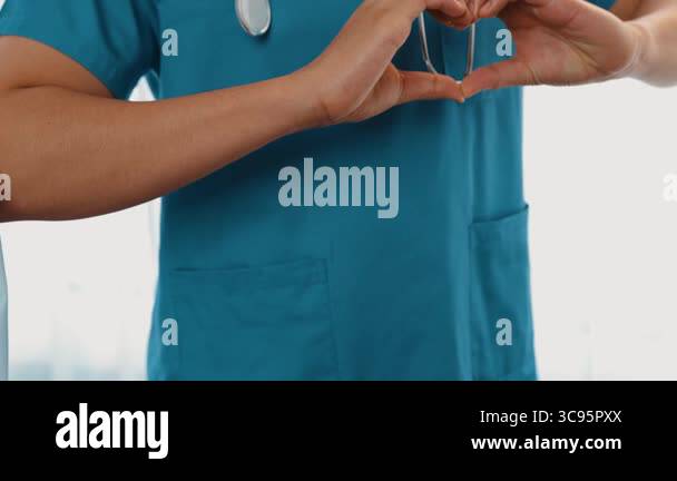 Professional team of medical staff stand in line, raise heart hand ...