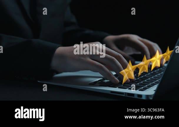 A close-up shot of hands typing on a laptop keyboard, surrounded by ...