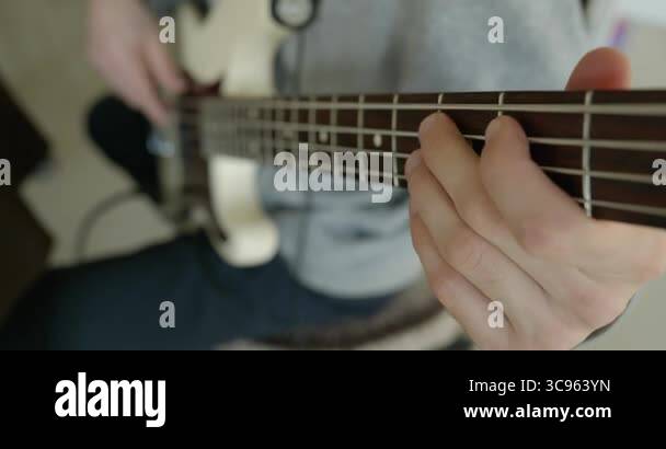Male Musician Practice Playing Music on Bass Guitar 4K 10-bit Stock ...
