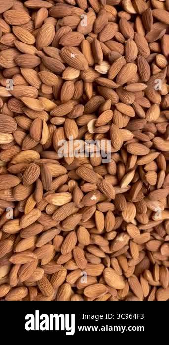 A close-up video showing a generous heap of almond kernels a rustic ...