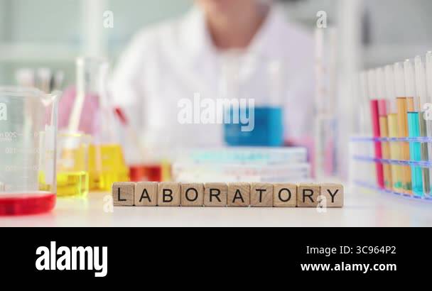 Word Laboratory on wooden cubes on table in chemical researching ...