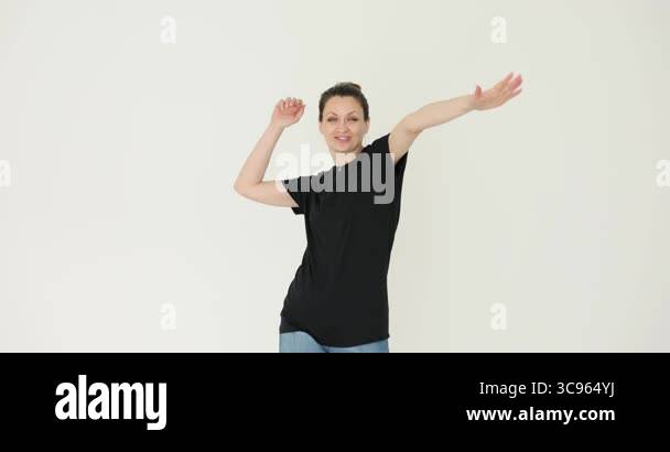 Young choreographer practices freestyle dance moves on white background ...
