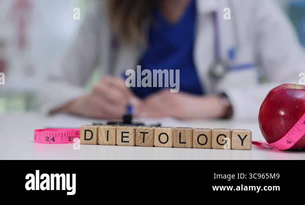 Female doctor nutritionist writes diet plan near wooden cubes with ...