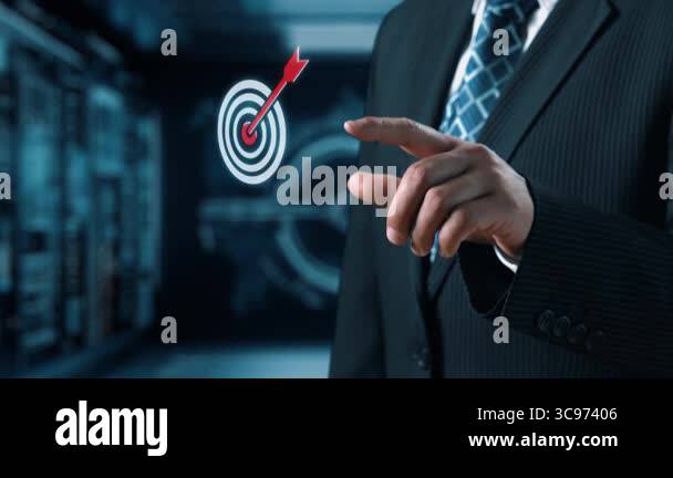A business professional stands alongside a target symbol and digital ...