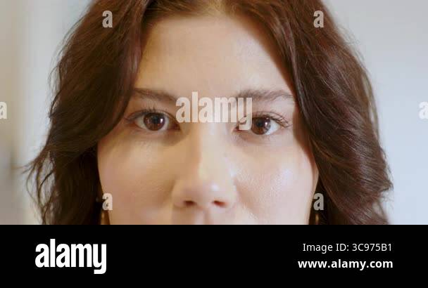 Close-up of woman's eyes, expressing calm and focus, with soft lighting ...