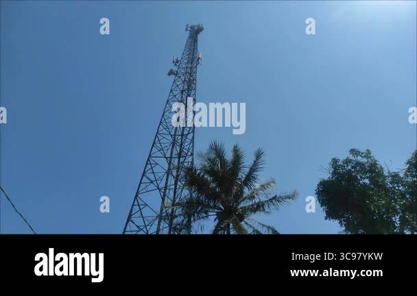 Telecommunication Tower Under Blue and Clear Sky With Wind Blown Trees ...