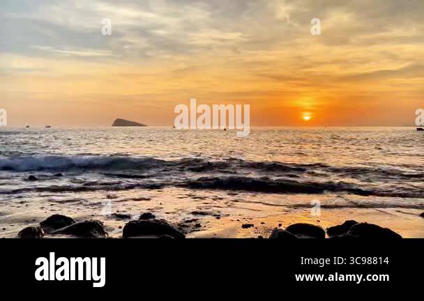 A breathtaking sunset view over tranquil, calm waters, with silhouetted ...