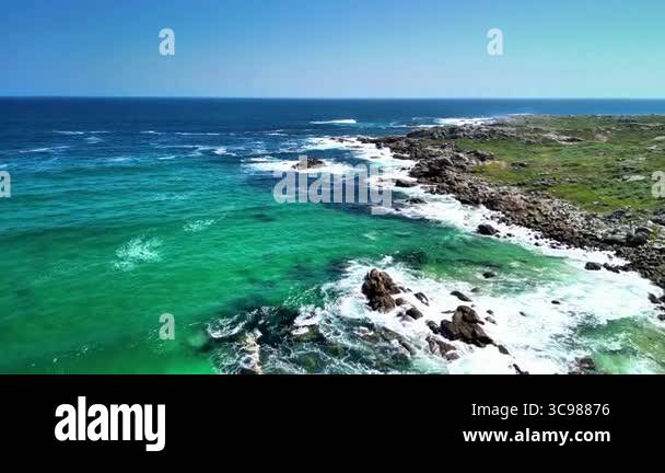 Experience stunning aerial views of a rugged shoreline meeting ...