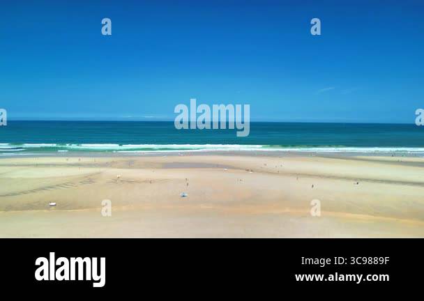 A stunning beach scene showcases golden sands and crystalclear waters ...