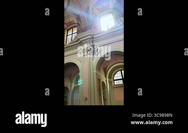 A ray of sunlight streaming through a window of a beautiful Catholic ...