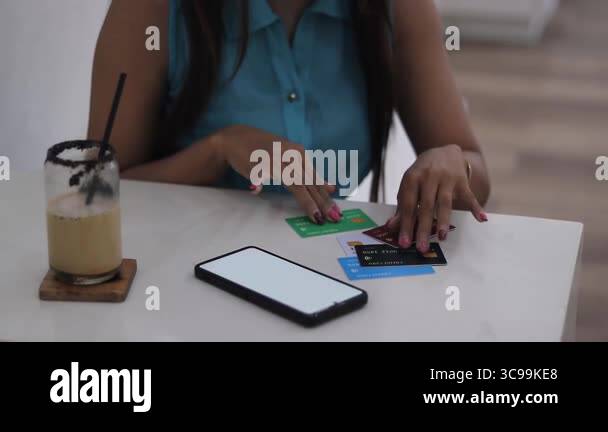 Woman uses a cellphone to pay with a credit card. The person pays for ...