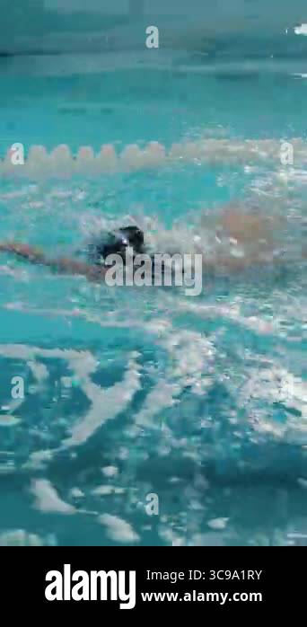 Swimmer splashing in pool lane, Swimmer creating splashes while ...