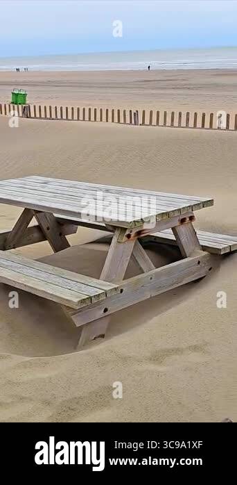 Picnic Tables Covered by Sand on Beach, Wooden picnic tables partially ...