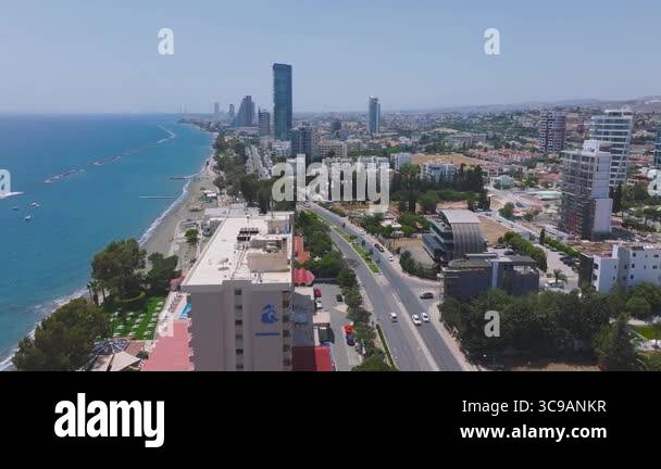 Aerial view of Limassol, Cyprus, showing modern skyscrapers, a sandy ...
