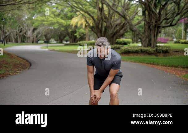Man runner has knee pain. Knee joint dislocation after running. Sport ...