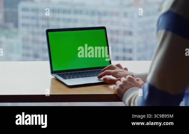 Man hands tapping chromakey computer touchpad at cityscape remote ...