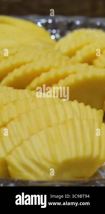 Half cutted cubes slices ripe mango on poolside background, nobody ...