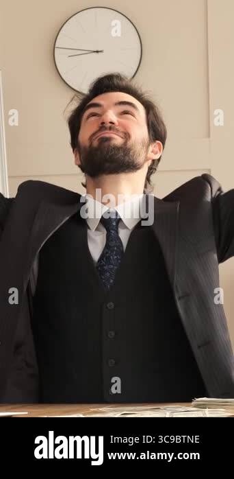 Content man celebrating success by scattering cash money in an office ...