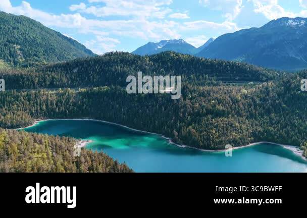 Beautiful turquoise lake surrounded by the rocks covered with pine-tree ...