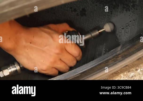 The tire repair process shows specialized tools for precise and ...