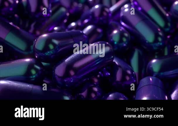 Multiple purple and green metallic capsules, reflecting light, create ...