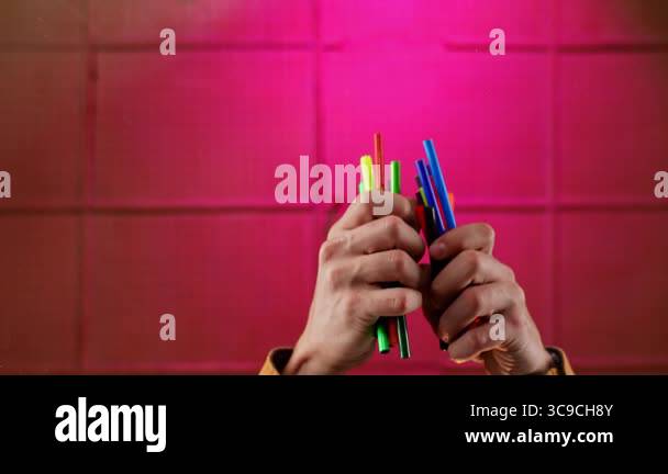 A dynamic image of a hand reaching out to various colorful pens ...