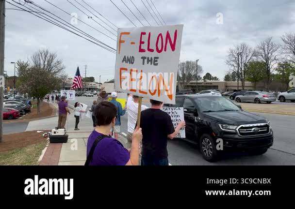 Duluth, GA / USA March 29, 2025: People display anti Elon Musk signs as ...