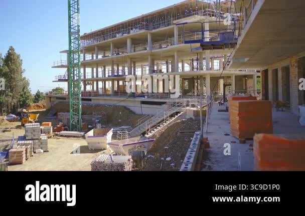 Modern building under construction with crane and scaffolding. High quality 4k footage Stock ...