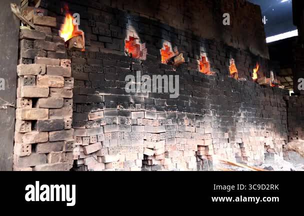 Red brick craftsman use wood for the process of burning red bricks at ...