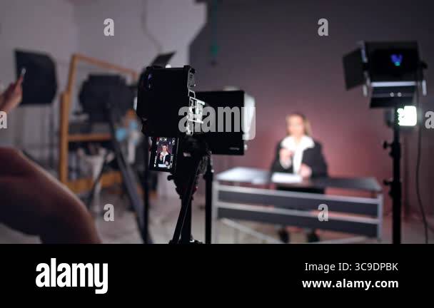 Backstage of the photo studio work. Male cameraman sits at camera ...