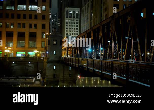Chicago city at night . Elevated transportation bridge across the river ...