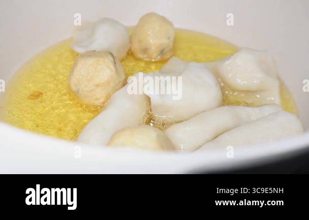 The process of frying various types of Pempek until cooked. Pempek is ...