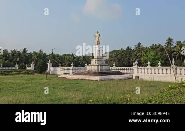 A statue in a grassy, open area surrounded by lush greenery Statue of ...