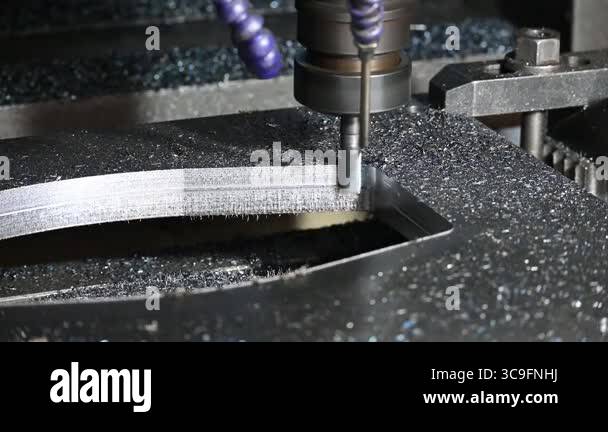 The CNC milling machine rough cutting the metal plate parts by solid ...