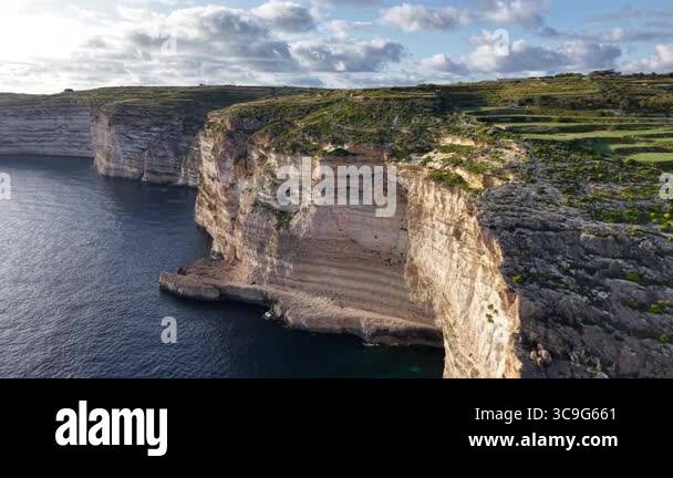 Explore the breathtaking coastline of Malta with its towering cliffs ...