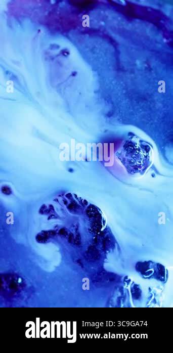 Vertical video. Blue spill. Shimmering current. Two jets liquid paint ...