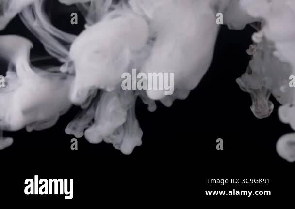 Double white smoke on dark backdrop. Footage for use in cinematic ...