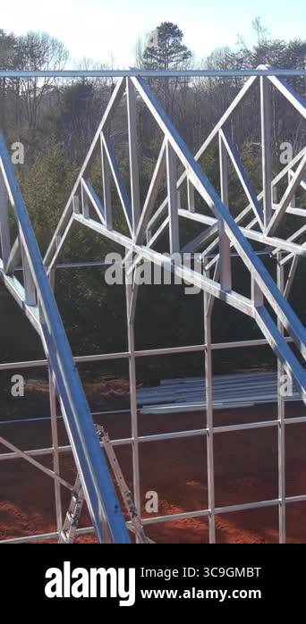 Large scale metal truss construction in progress with silver steel ...