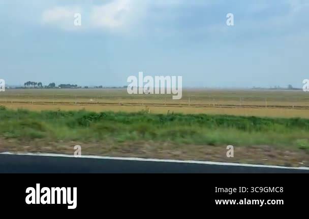 Roadside view and road, landscape and field, view from the car window ...