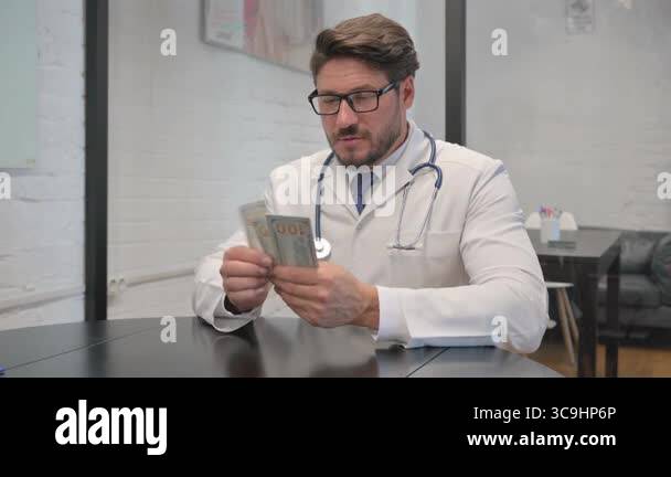 Middle Aged Doctor Counting Money in Clinic Stock Video Footage - Alamy