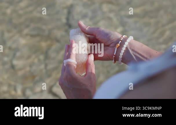 girl holds salt crystals in hand. female hand holds natural salt ...