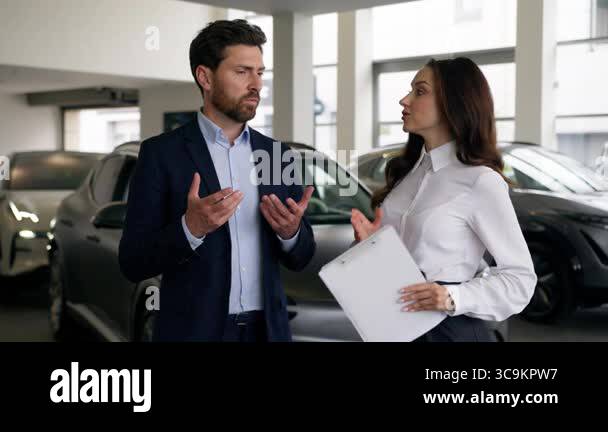 Two people talking in car salon businessman man client talk with ...