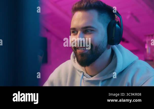 Smiling Caucasian man male guy gamer streamer enjoying playing video ...