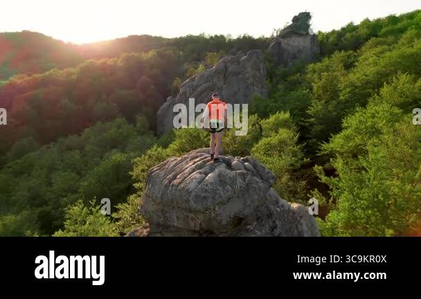 Aerial view of climber standing atop rock formation at Dovbush Rocks in ...