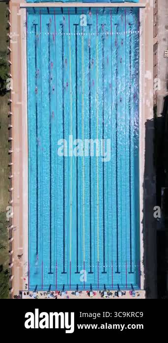 Aerial top view of an outdoor Olympic-size swimming pool with multiple ...