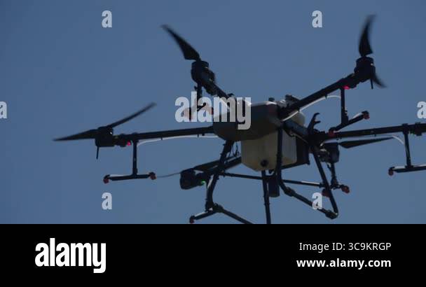 Aerial drone flying over a cultivated farm field during a crop ...