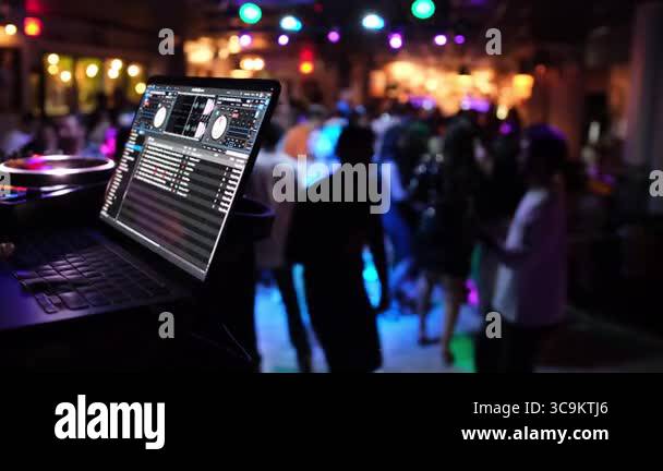 A vibrant dynamic scene showcasing a DJ setup with an energetic crowd ...