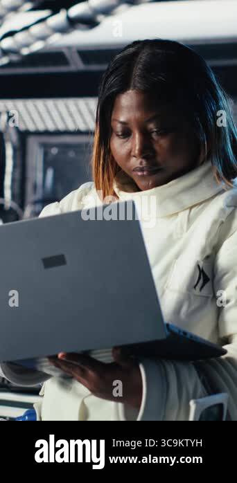 Vertical video Close up of astronaut using tablet to check logs after ...